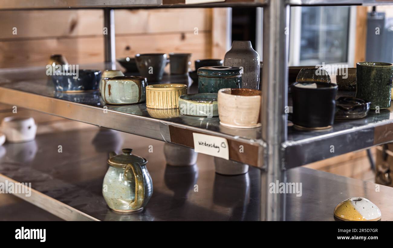 Shelf full of different colours shapes and sizes handmade pottery Stock ...