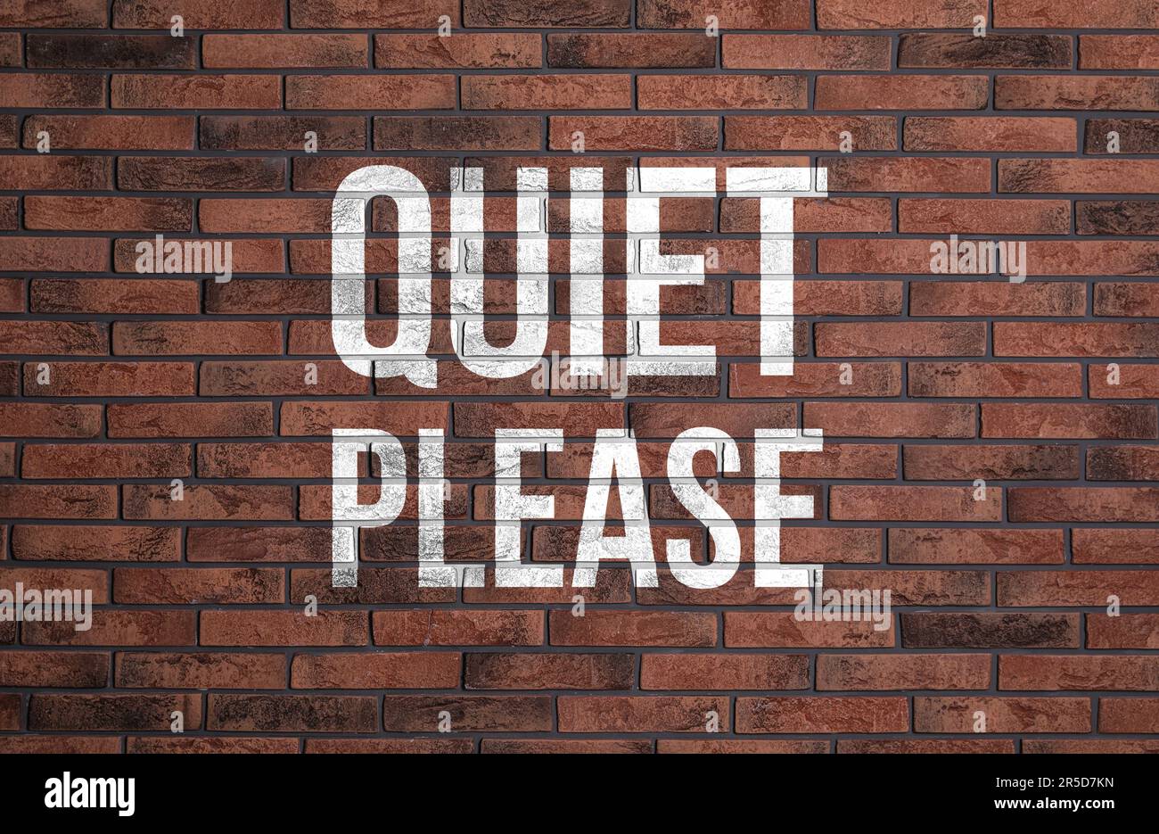 Phrase Quiet Please on red brick wall Stock Photo - Alamy