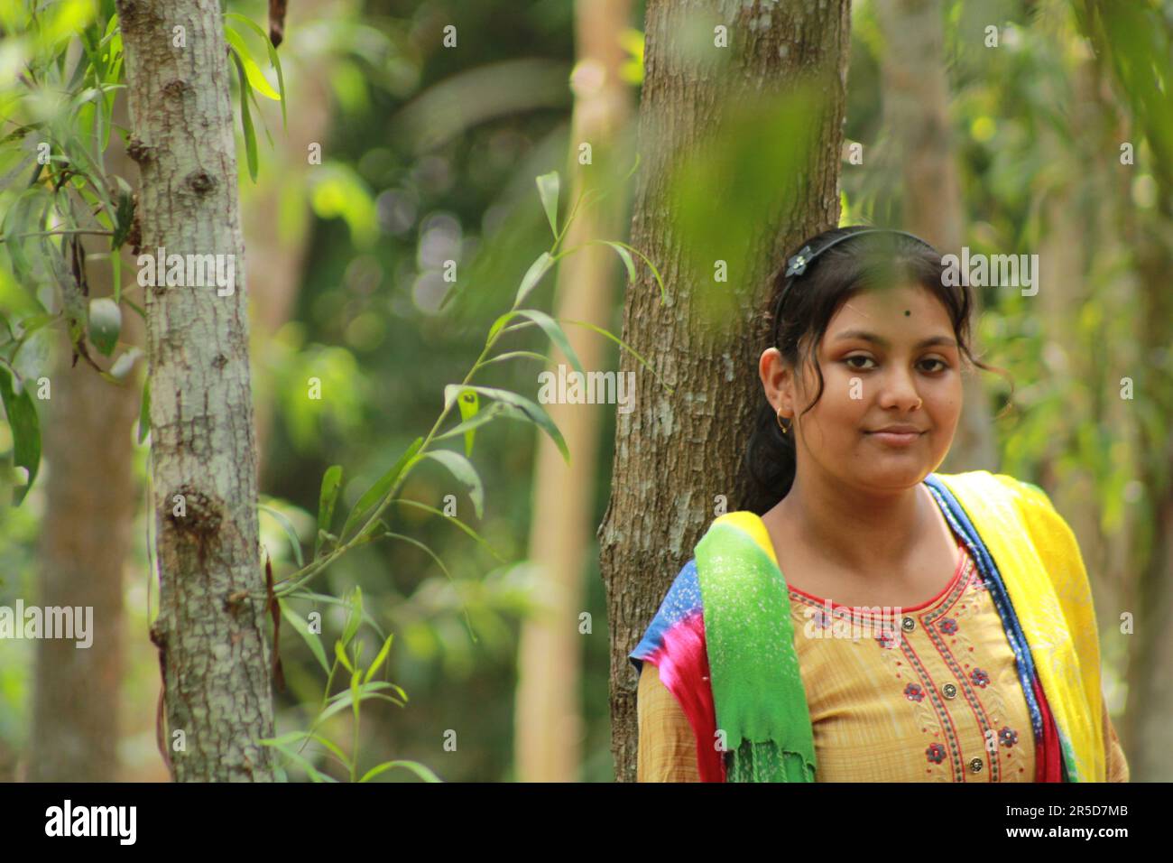 Close-up portrait of a Indian teenage girl looking at camera over ...