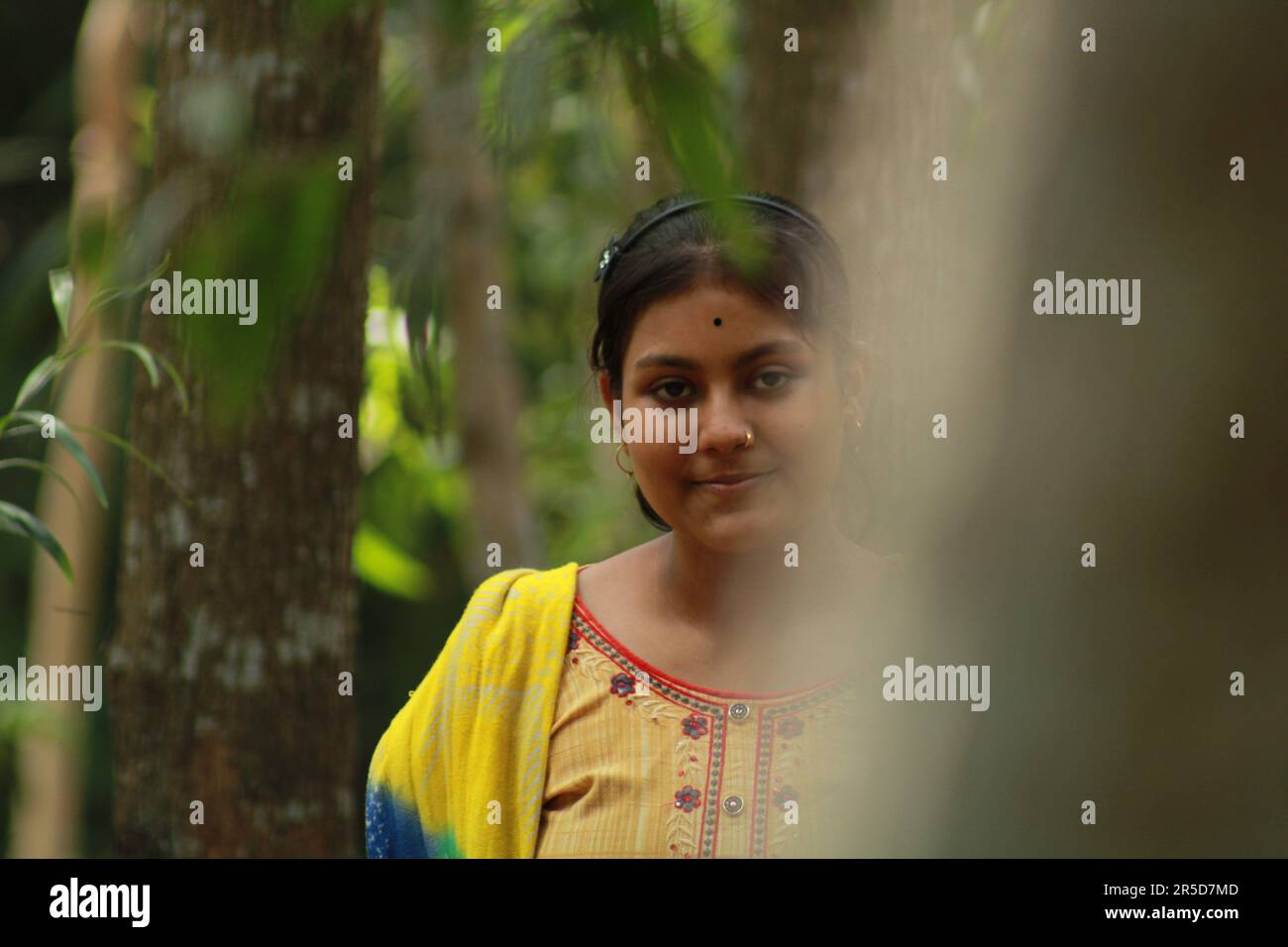 Close-up portrait of a Indian teenage girl looking at camera over ...