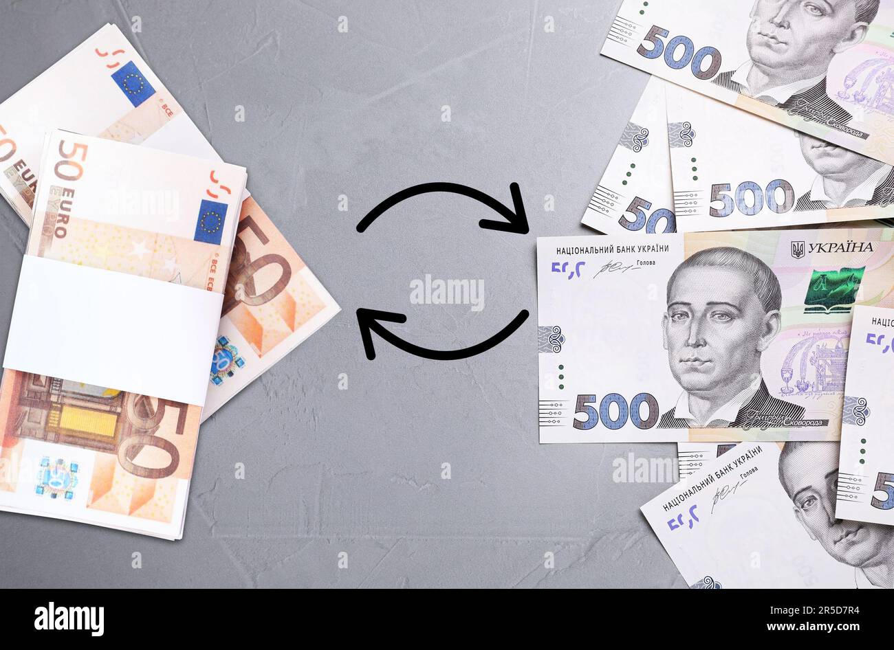 Currency exchange. Circle arrows between hryvnias and euro banknotes on ...