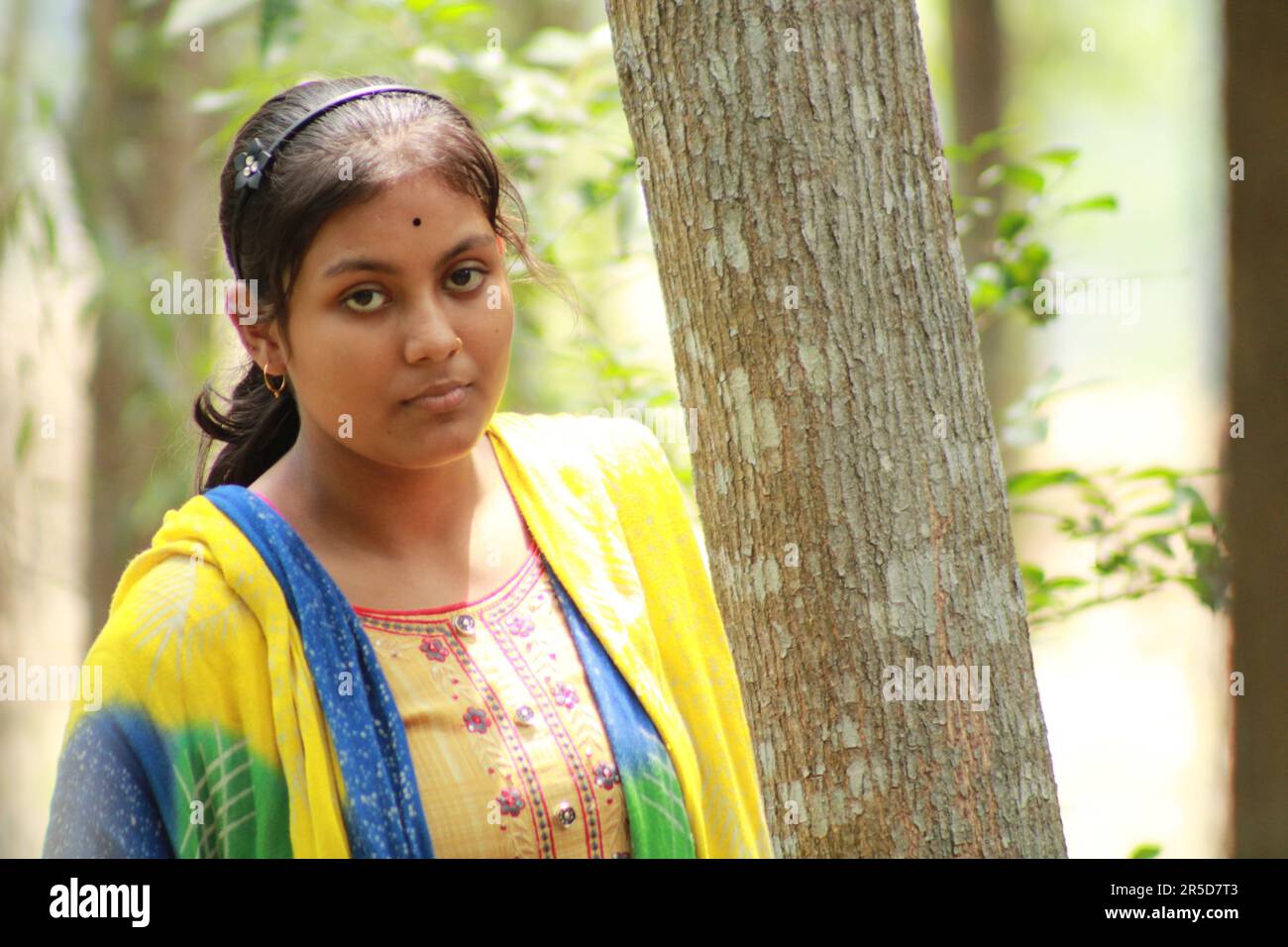 Close-up portrait of a Indian teenage girl looking at camera over ...