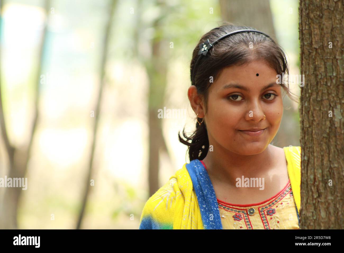 Close-up portrait of a Indian teenage girl looking at camera over nature background Stock Photo ...