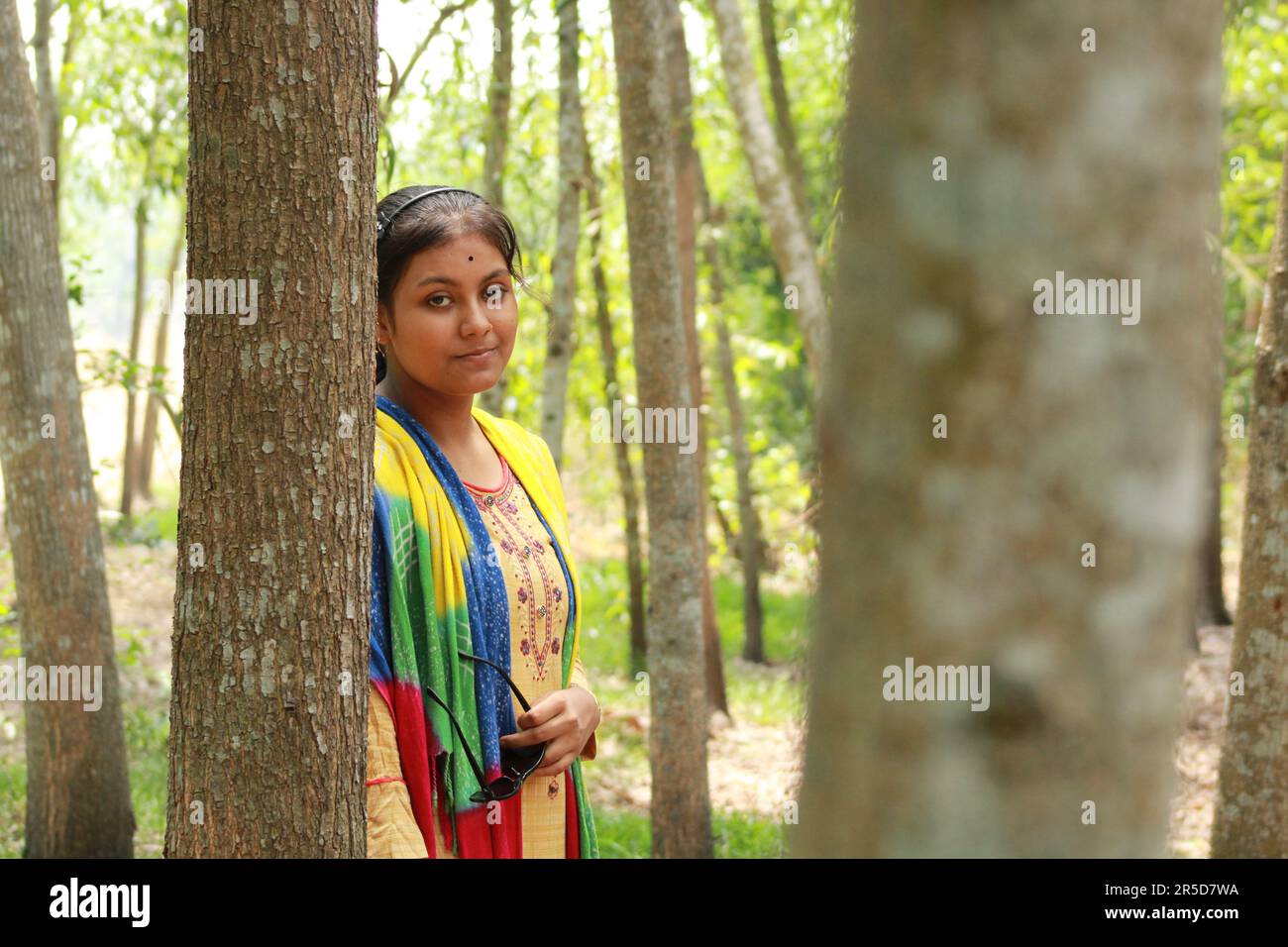 Close-up portrait of a Indian teenage girl looking at camera over ...