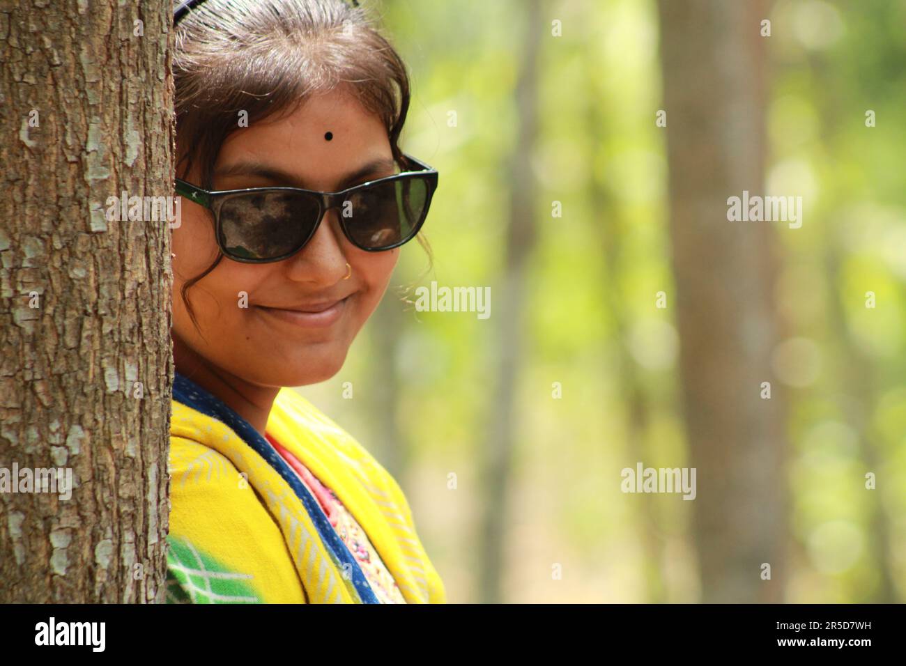 Close-up portrait of a Indian teenage girl looking at camera over ...