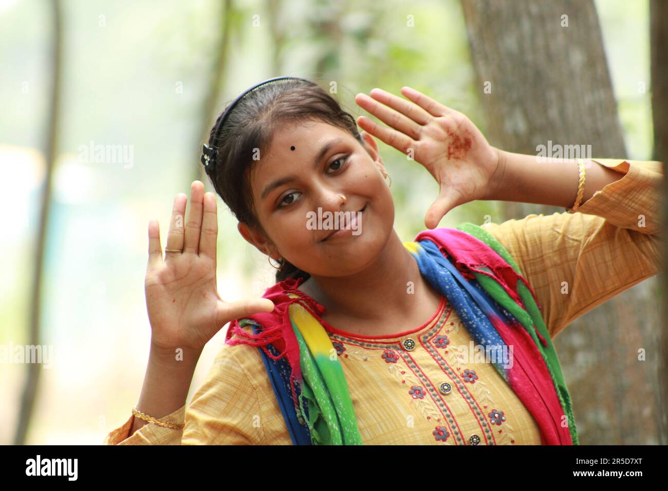 Close-up portrait of a Indian teenage girl looking at camera over ...