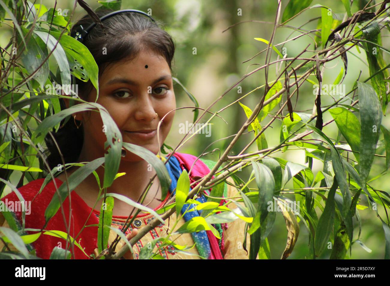 Close-up portrait of a Indian teenage girl looking at camera over ...