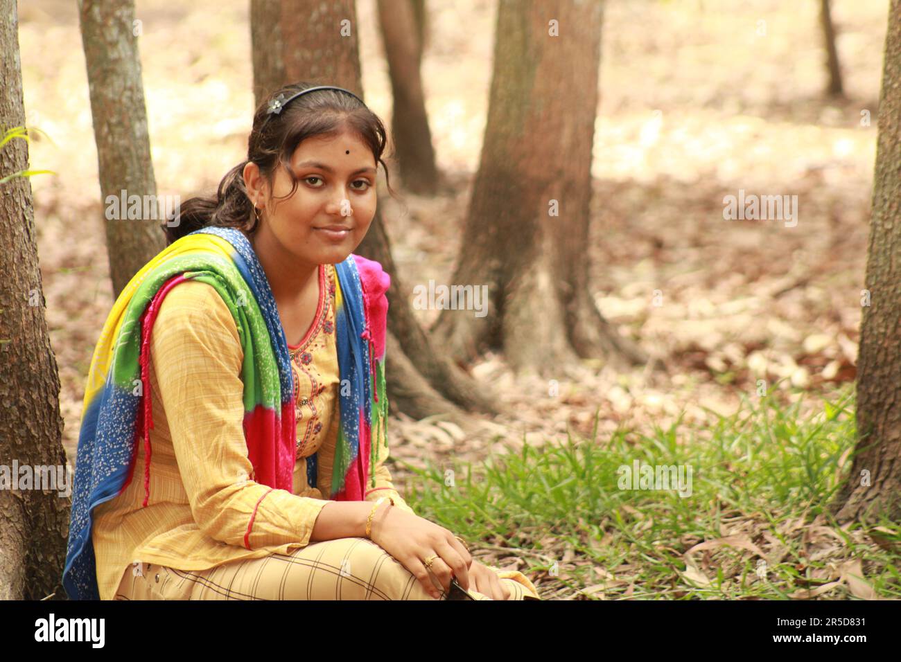 Close-up portrait of a Indian teenage girl looking at camera over ...