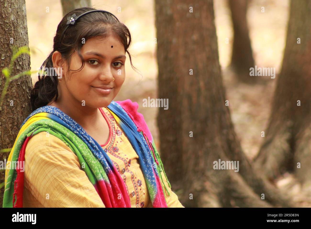 Close-up portrait of a Indian teenage girl looking at camera over ...