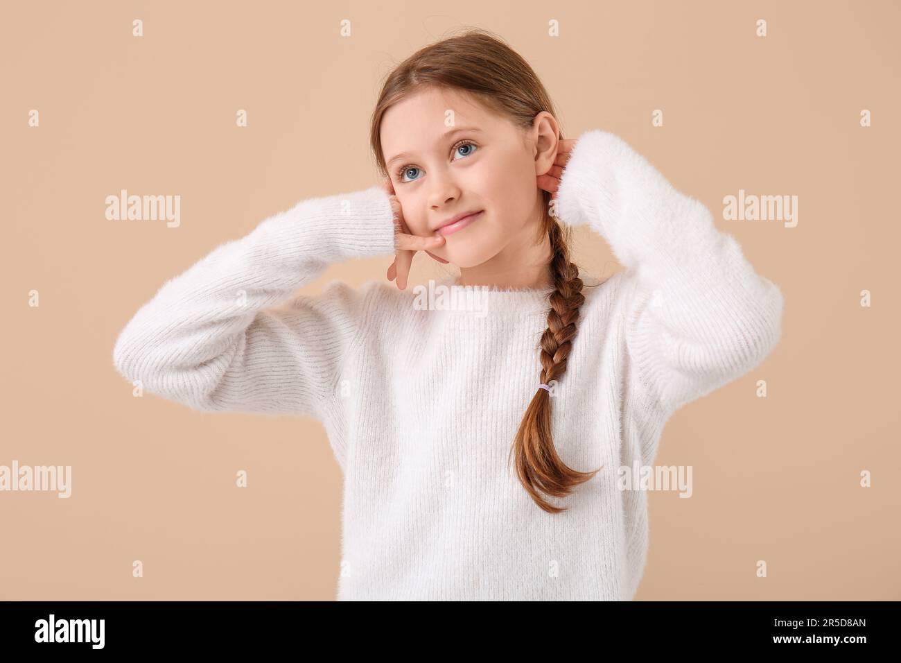 Little girl showing "call me" gesture on beige background Stock Photo ...
