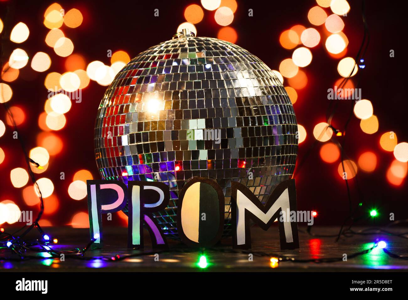 Word PROM with disco ball on dark table against blurred lights Stock ...