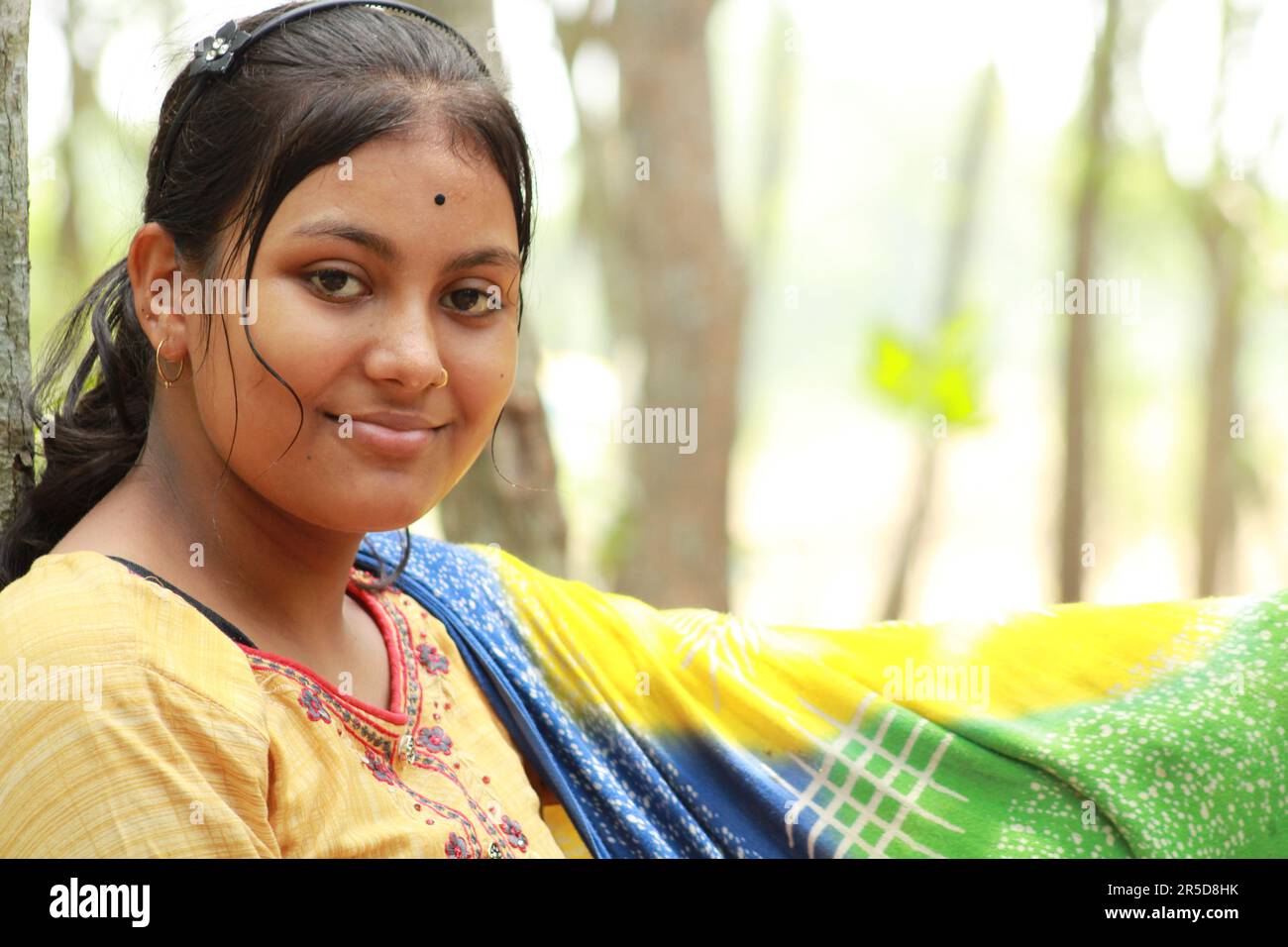 Close-up portrait of a Indian teenage girl looking at camera over ...