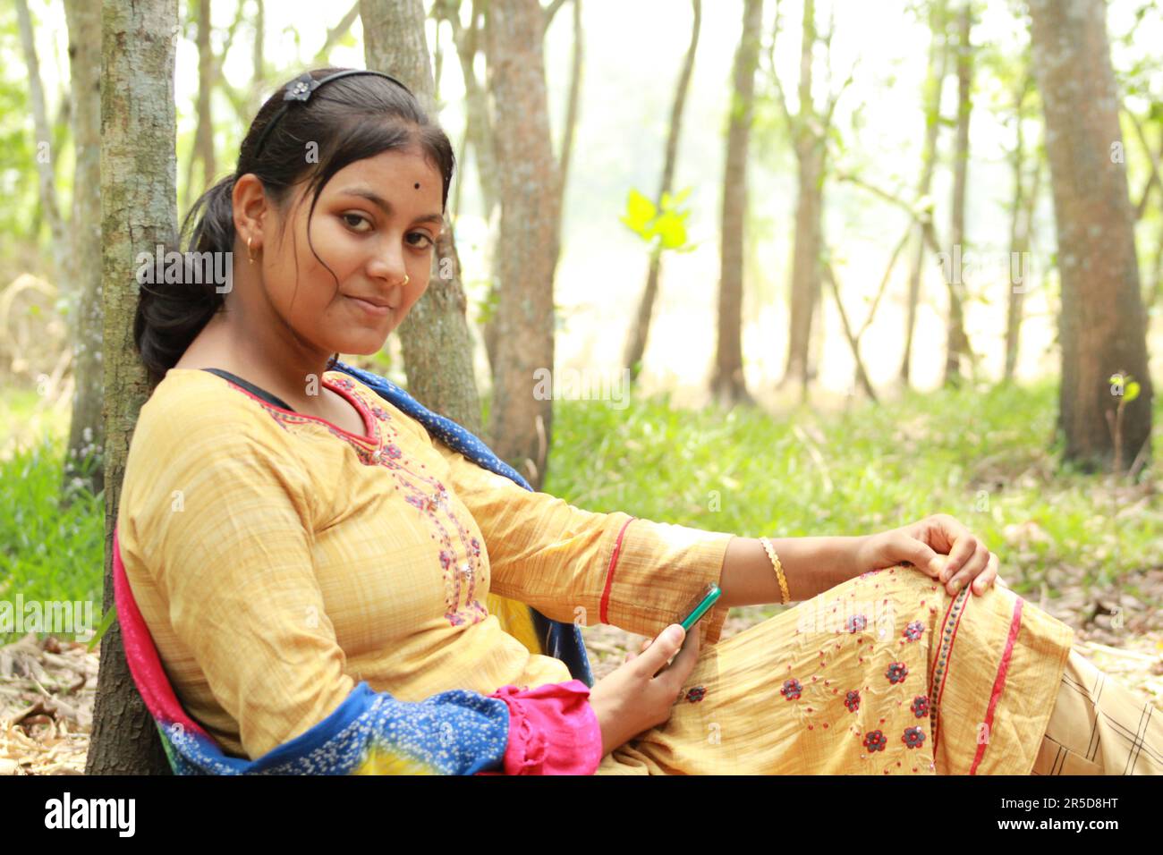 Close-up portrait of a Indian teenage girl looking at camera over ...