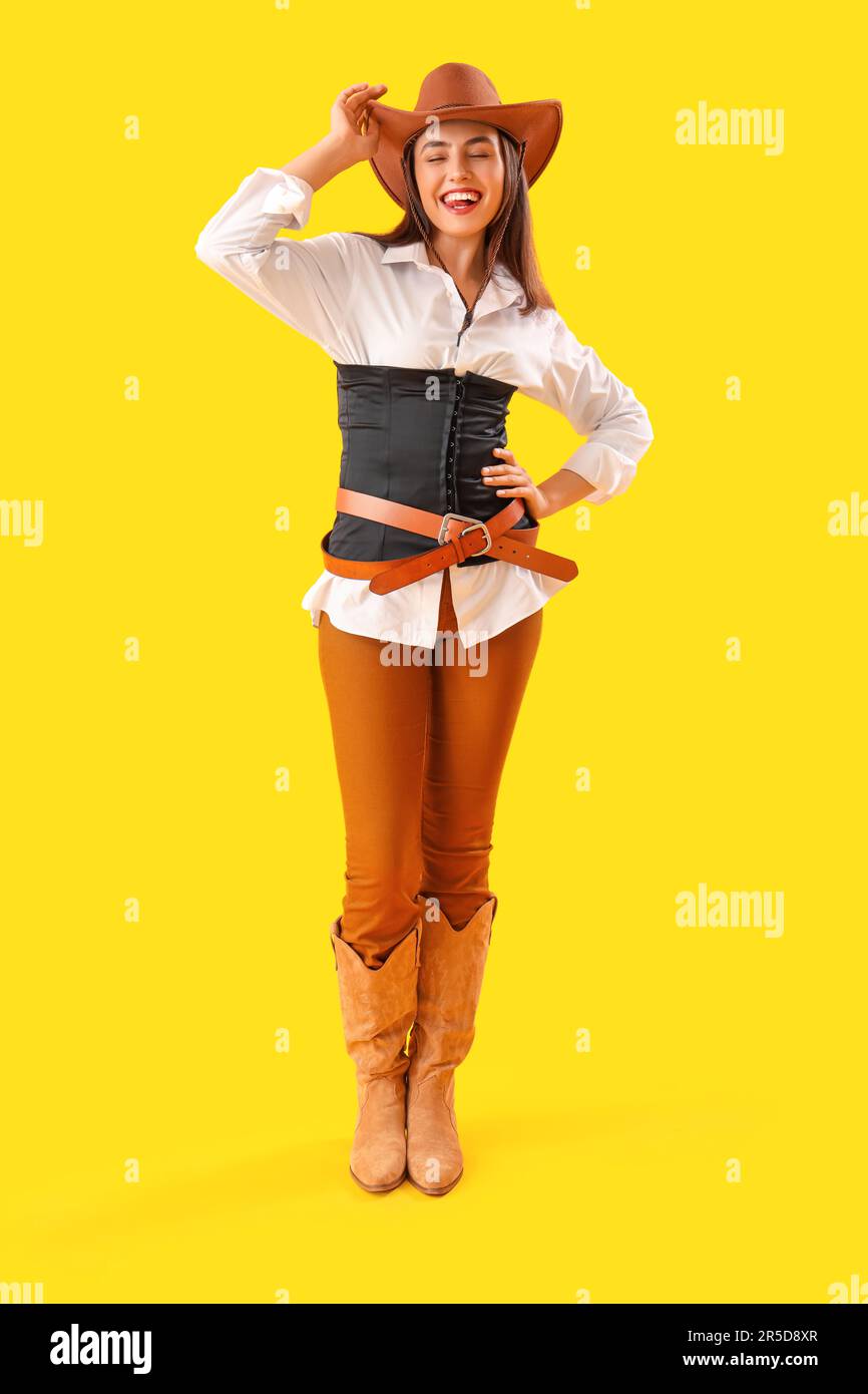 Beautiful cowgirl on yellow background Stock Photo - Alamy