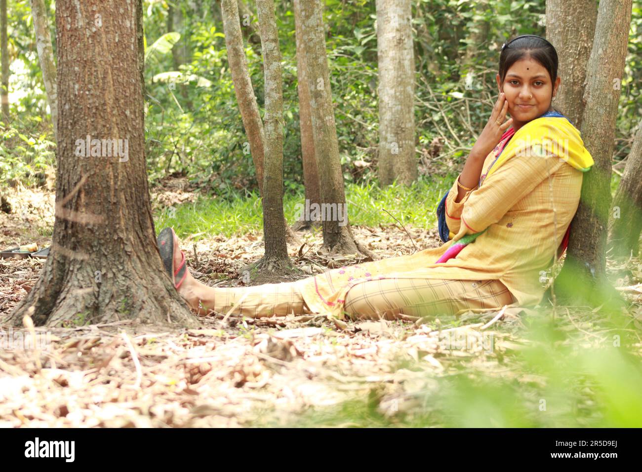 Close-up portrait of a Indian teenage girl looking at camera over ...
