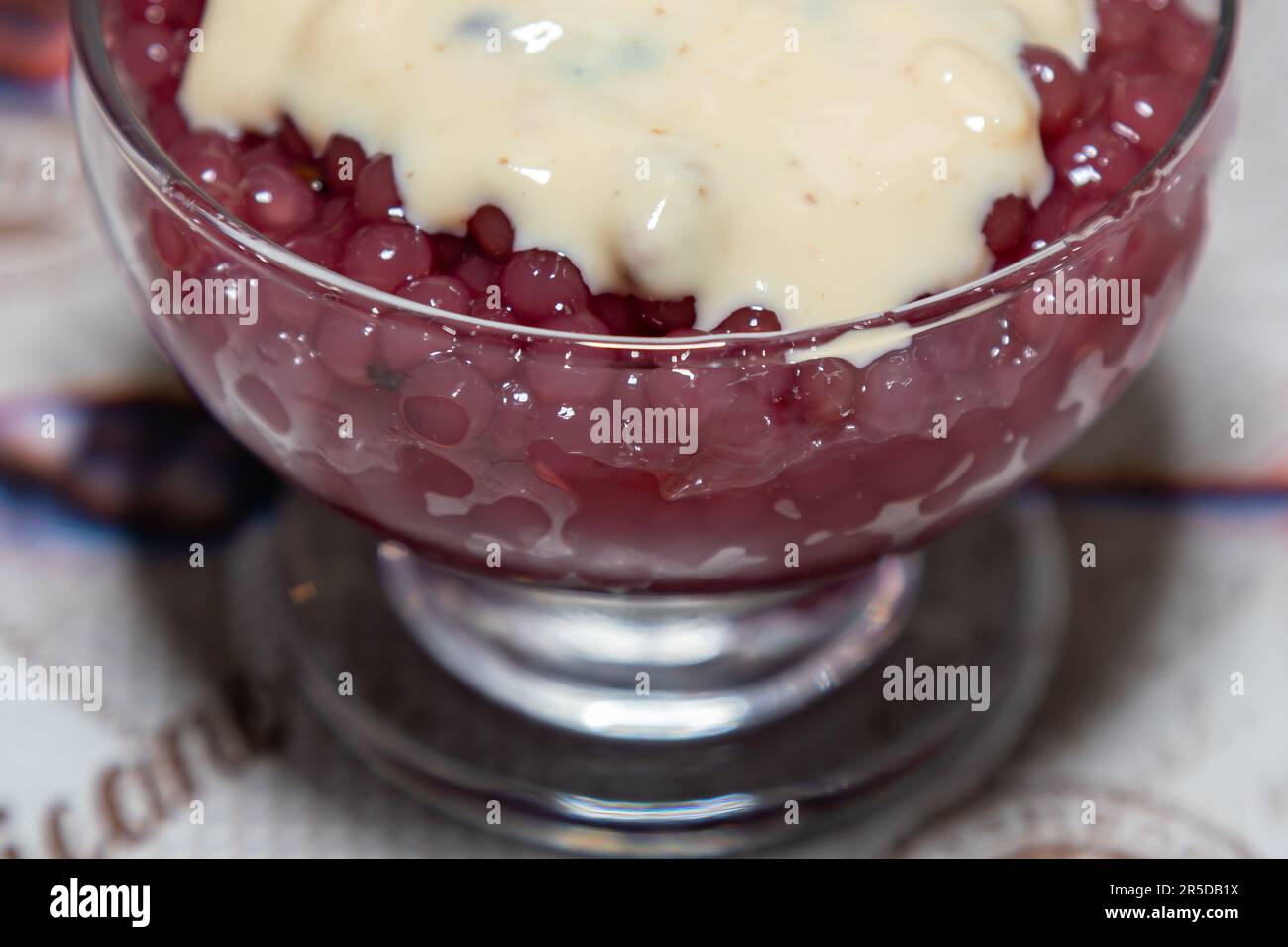 Red wine sago with vanilla cream, traditional cultural dessert from ...