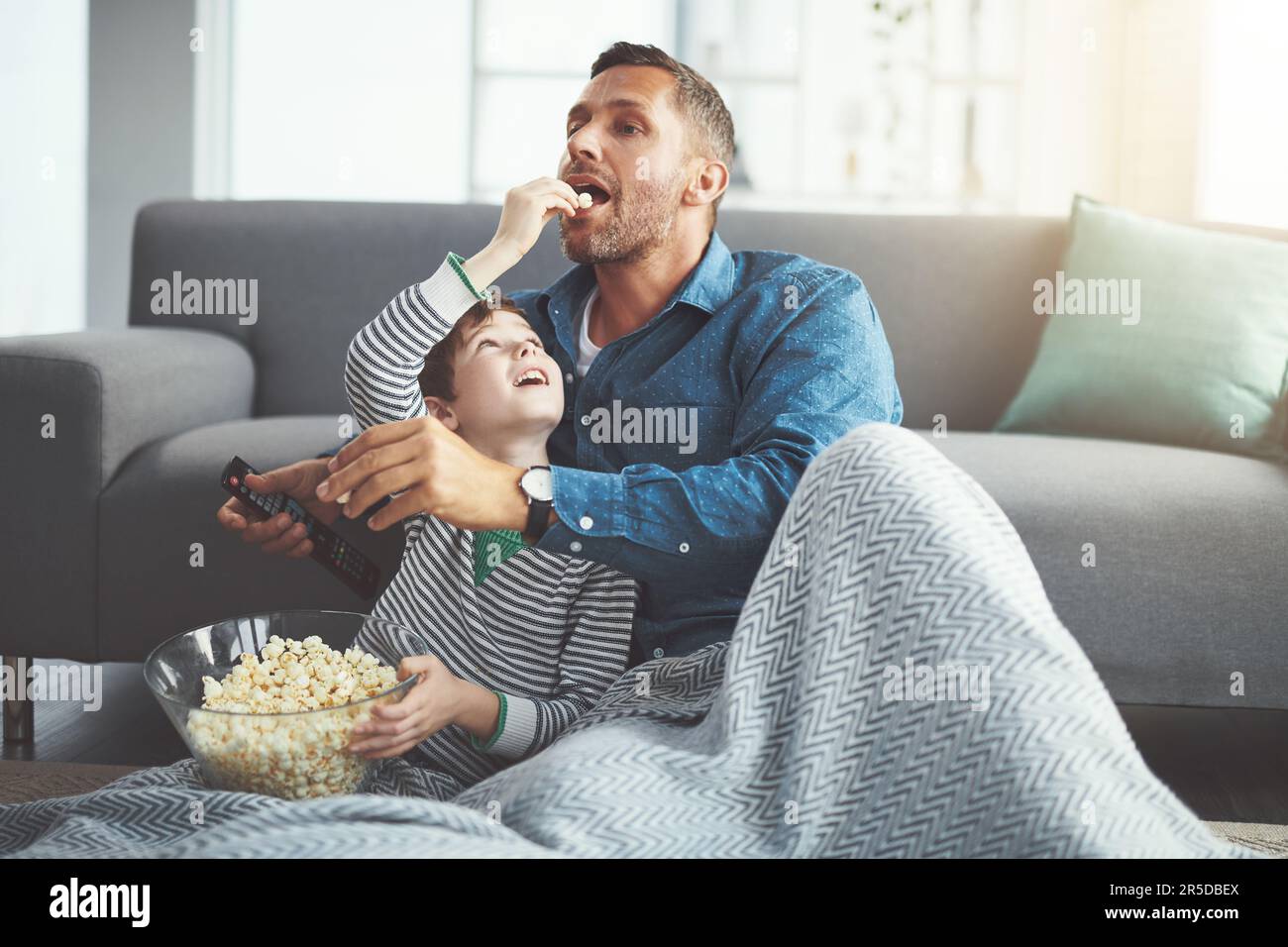 My extra pair of hands. a carefree young boy and his father watching a ...