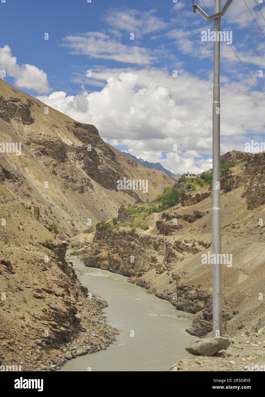 Beautiful view of flowing river in between rocky mountains with clouds ...
