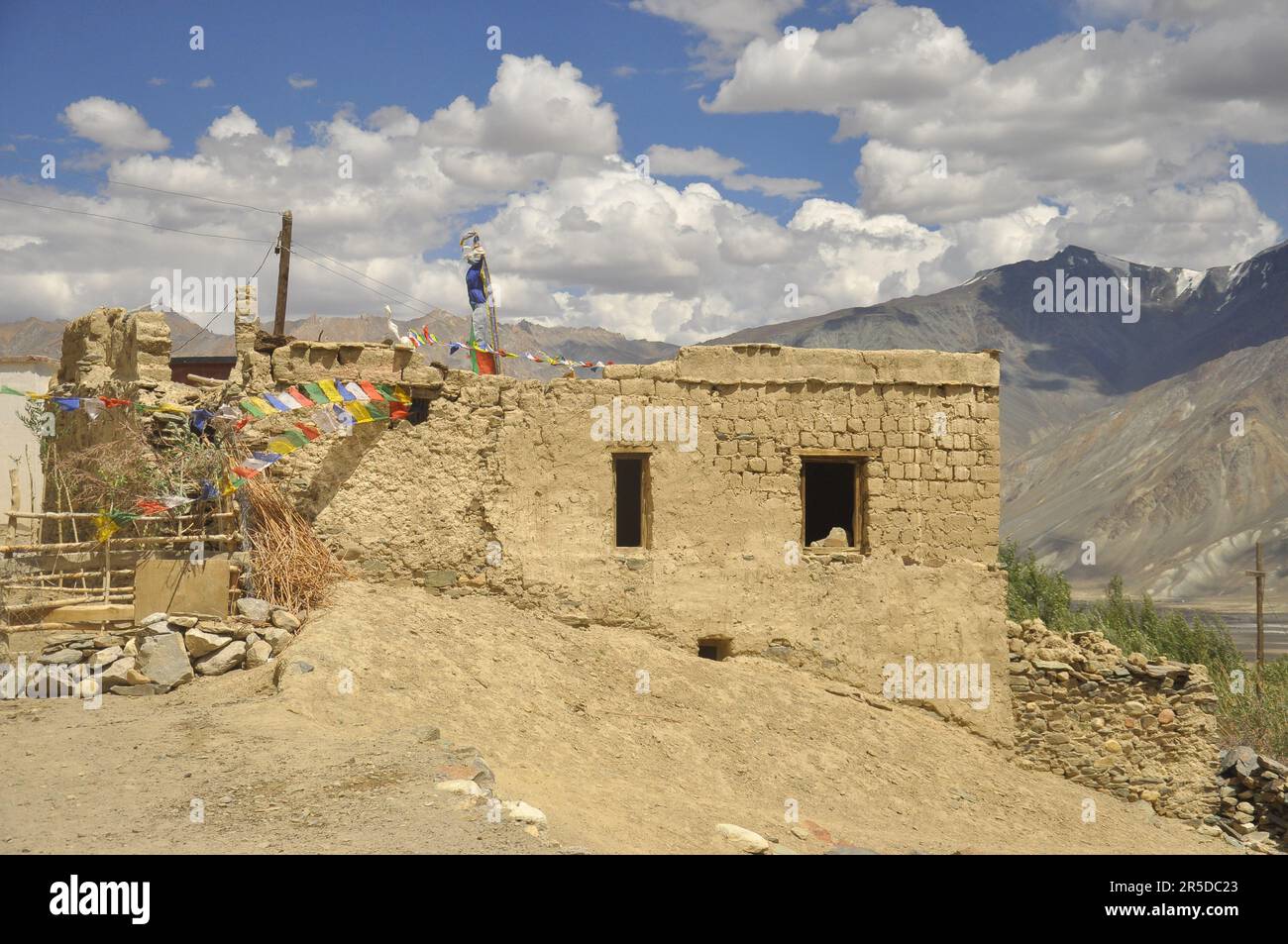 Side view of a abandoned ladakhi house with tibetan prayer flags in ...