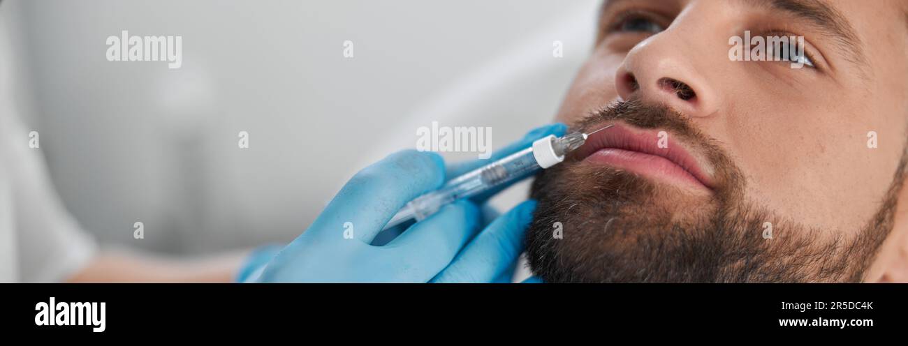 Attractive man with beard undergoes lip augmentation procedure with ...