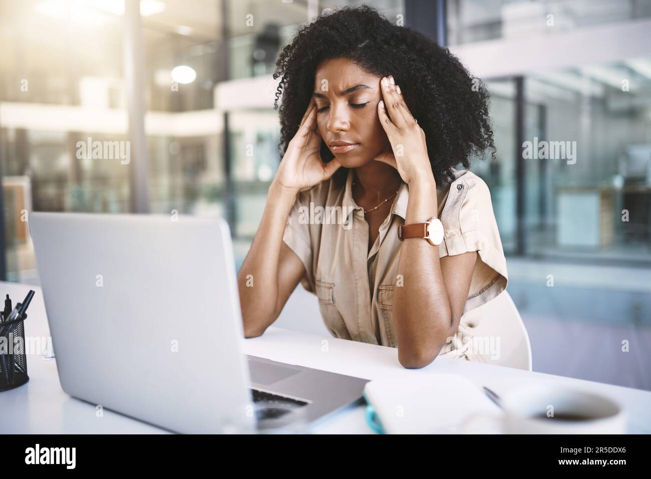 Every job has its stressful moments. a young businesswoman looking ...