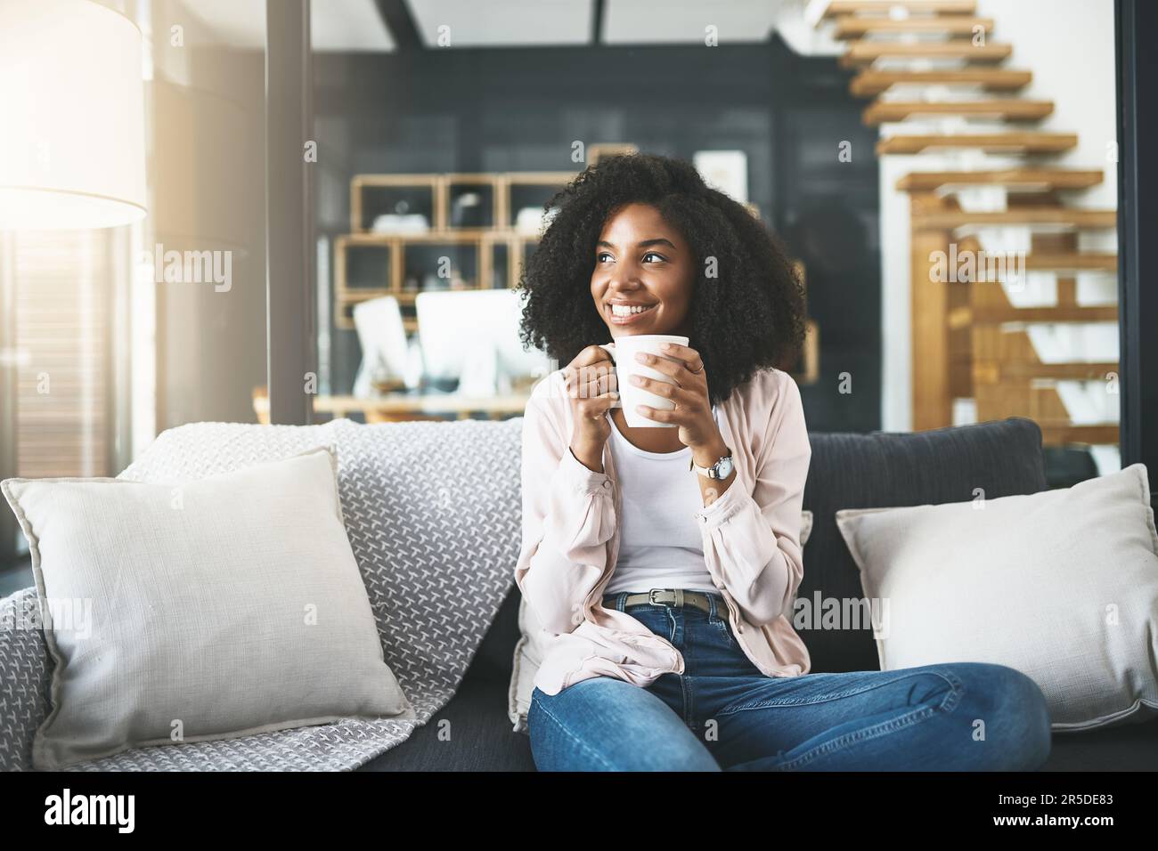 Is there anything coffee cant do. an attractive young woman relaxing at ...
