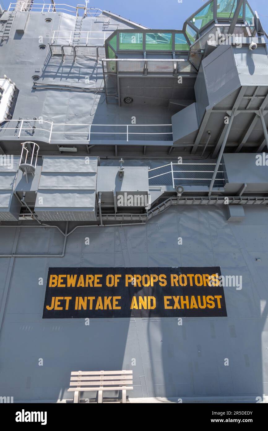 The island of the USS Yorktown has a warning sign saying, "Beware of ...