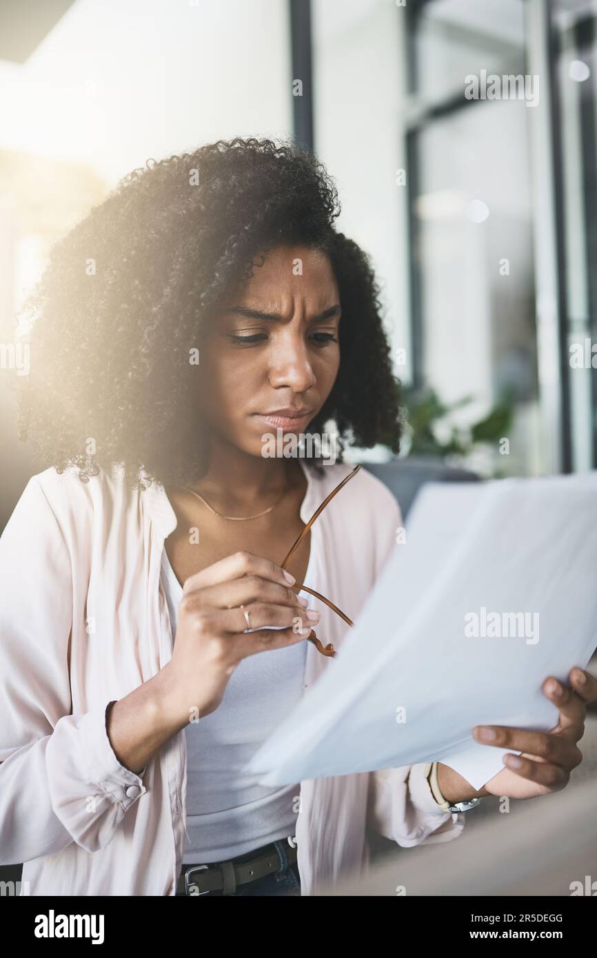 Something doesnt look right. an attractive young woman relaxing at home Stock Photo - Alamy