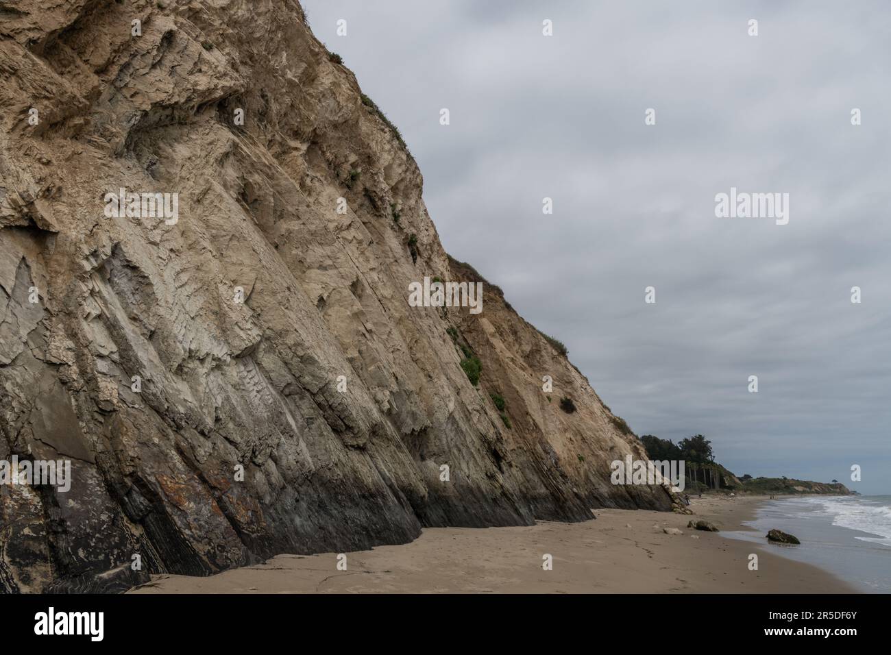 Natural oil seep at the bottom of the coastal cliff in Goleta, Southern ...