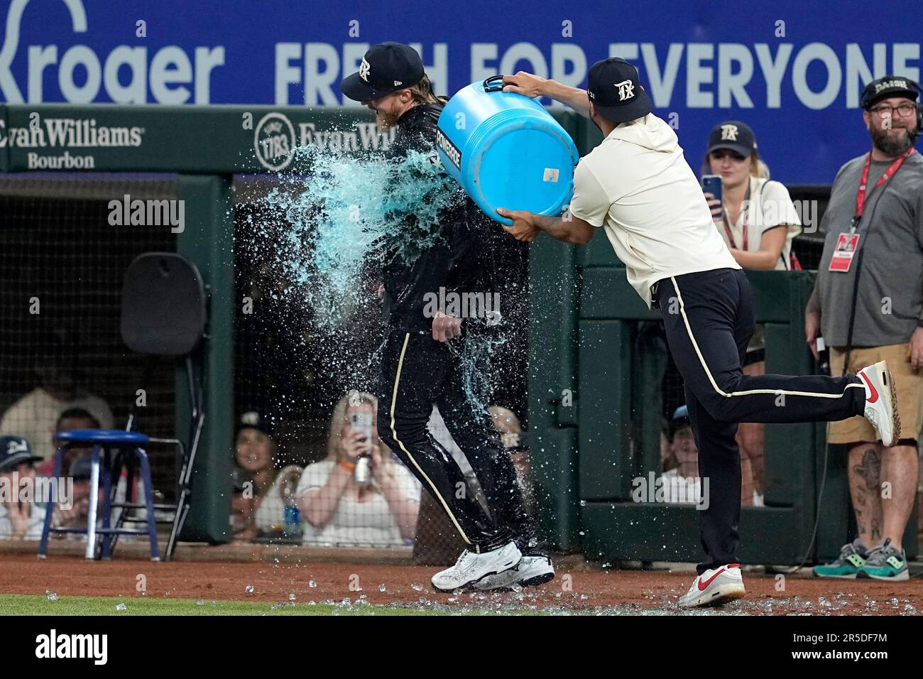 Texas Rangers' Jon Gray, left, is doused by Martin Perez, right, after ...