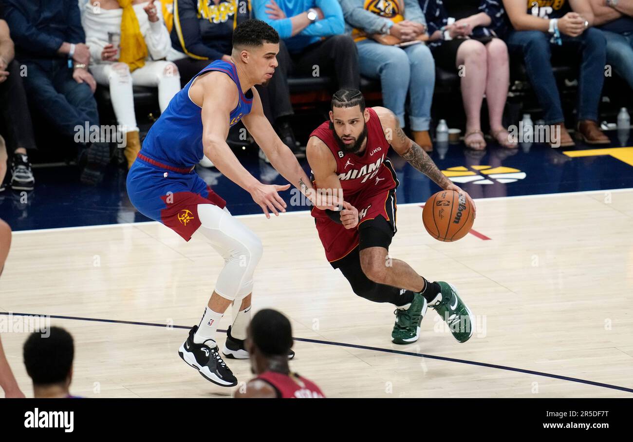 Miami Heat forward Caleb Martin (16) drives past Denver Nuggets forward ...