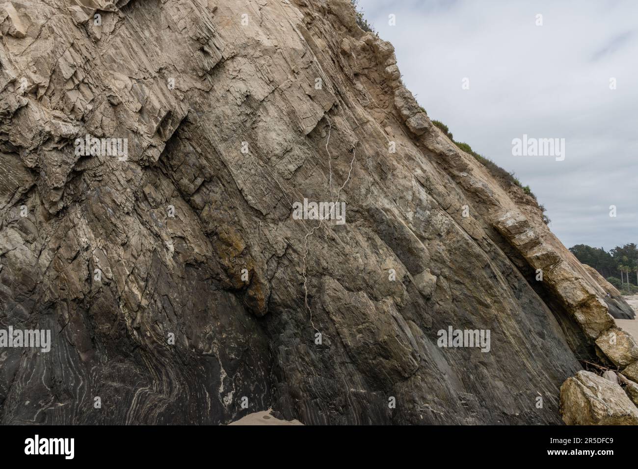 Natural oil seep at the bottom of the coastal cliff in Goleta, Southern ...