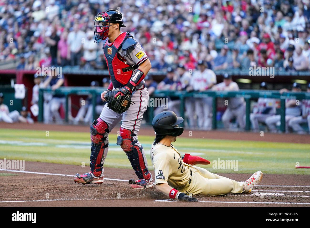 Arizona Diamondbacks' Corbin Carroll, right, scores as Atlanta Braves catcher Sean Murphy, left ...