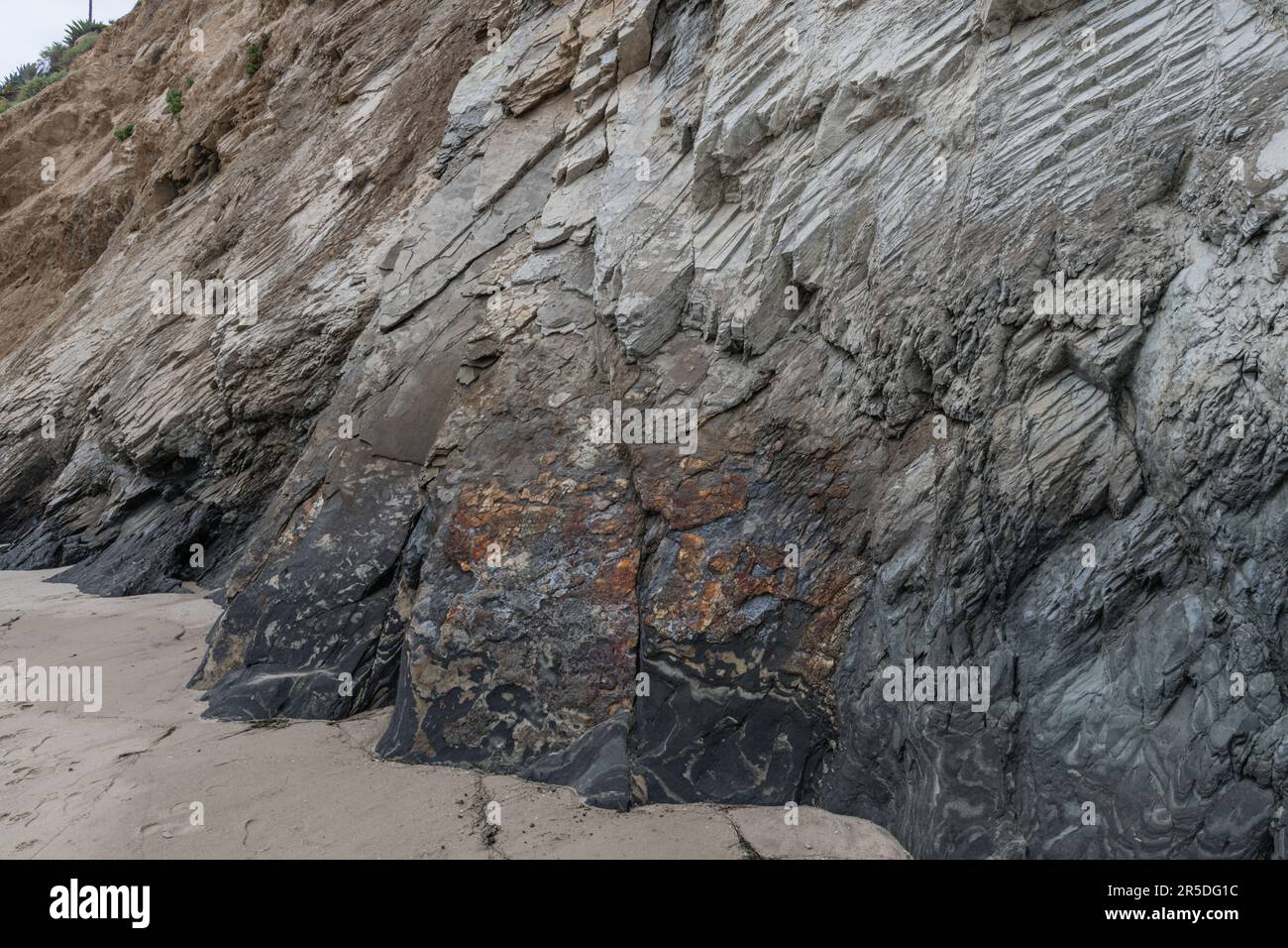 Natural oil seep at the bottom of the coastal cliff in Goleta, Southern ...
