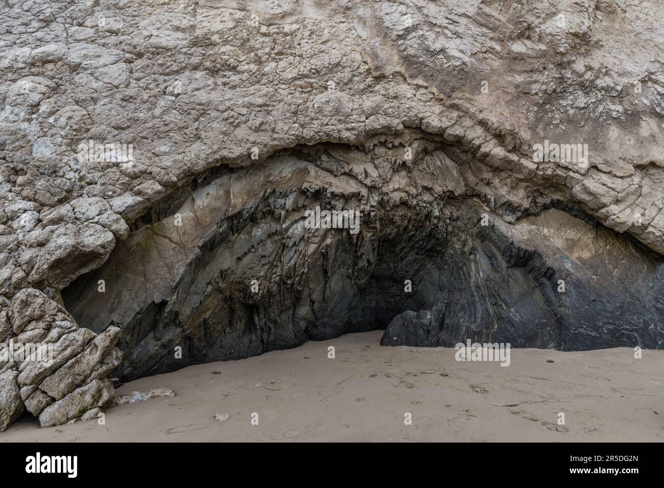 Natural oil seep at the bottom of the coastal cliff in Goleta, Southern ...