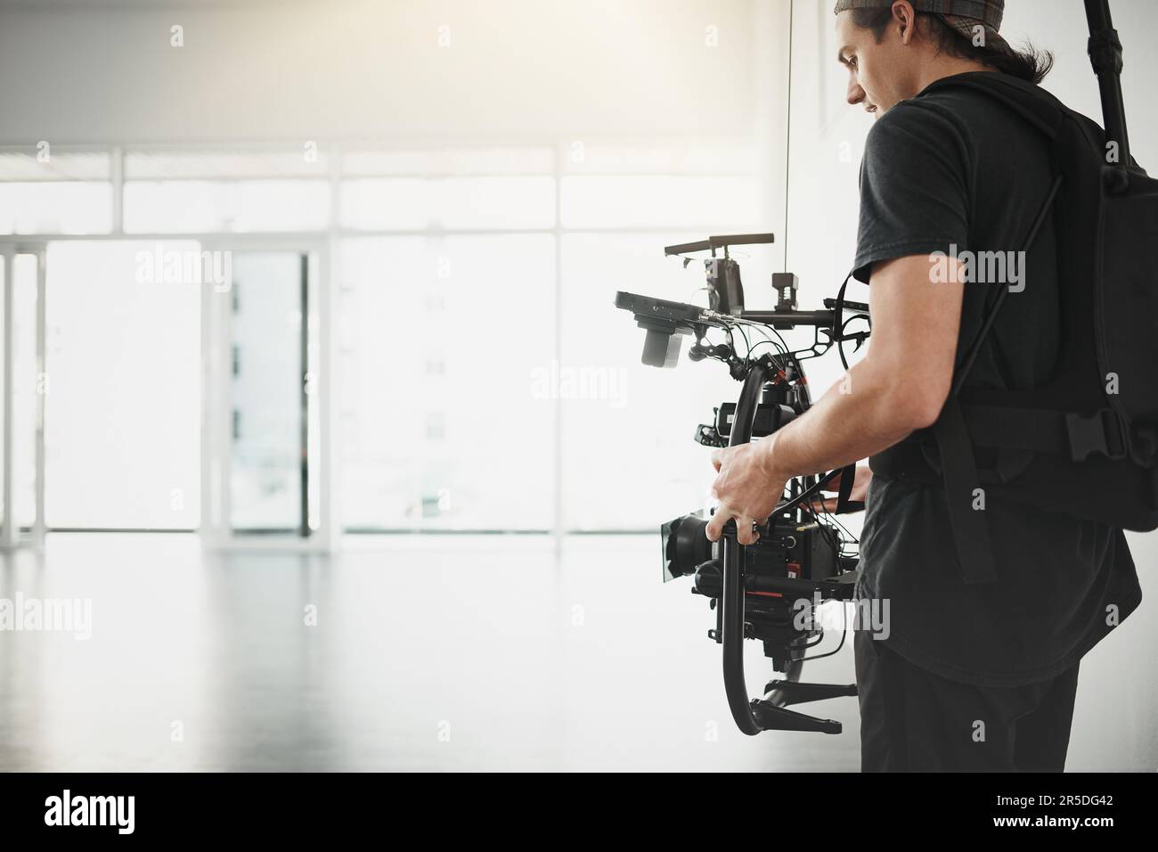 Moving with the action. Behind the scenes shot of a camera operator ...