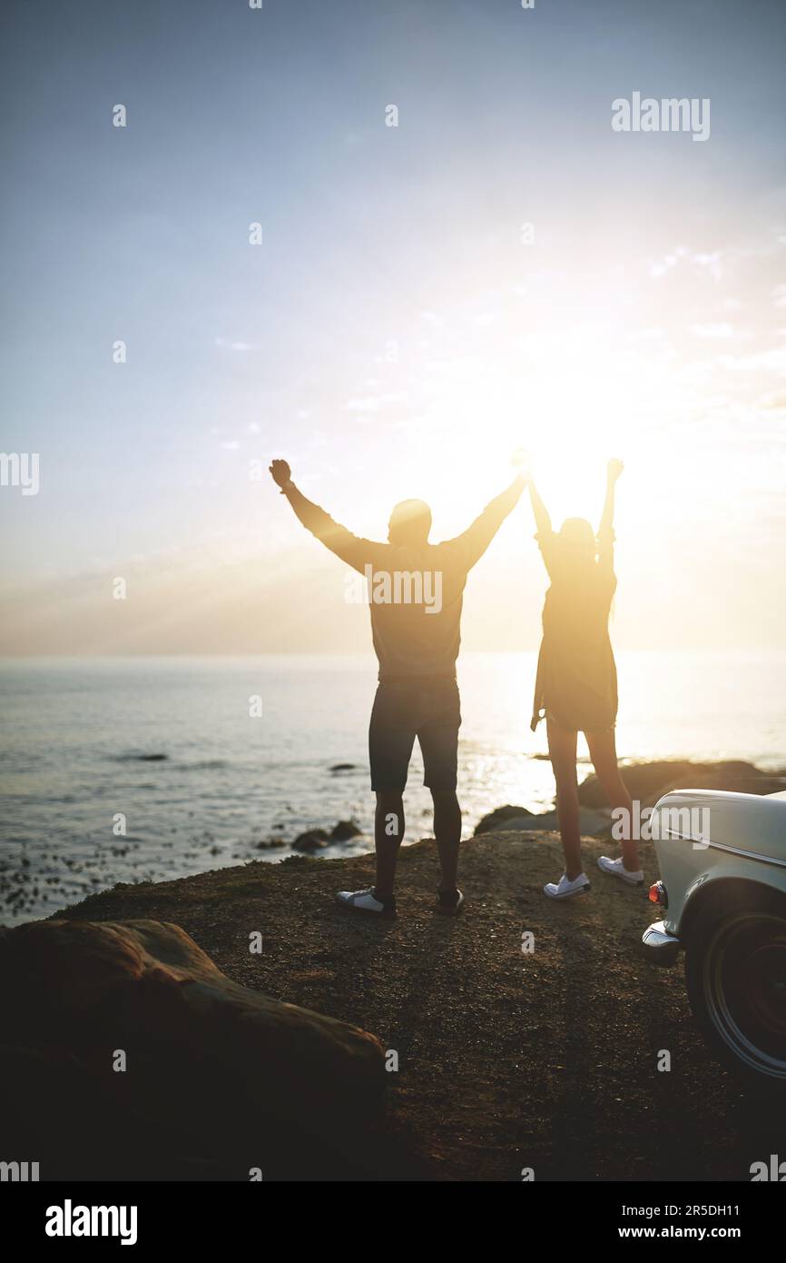Live in the moment. a young couple making a stop at the beach while out ...