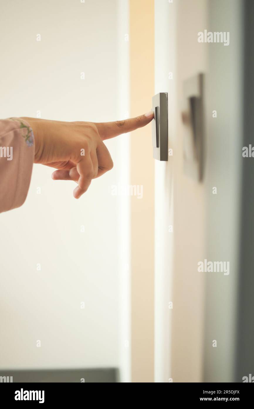 A finger turning on lighting switch Stock Photo - Alamy