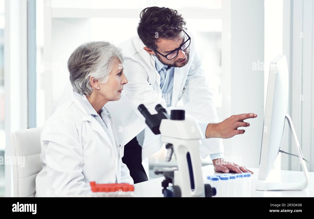 The old and new generation of doctors working together. two focused ...