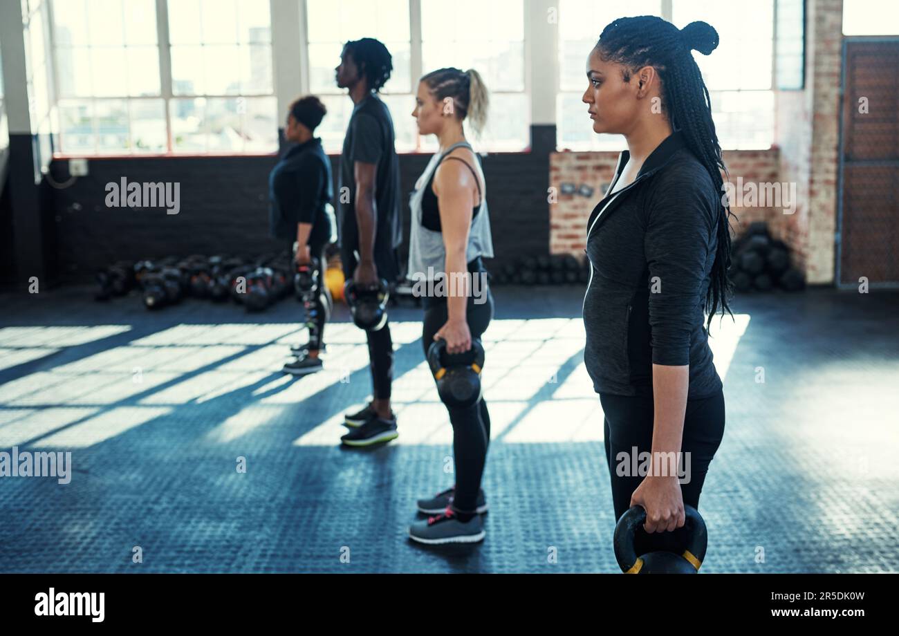 Nothing can stop us. a focused group of young people standing in a row ...