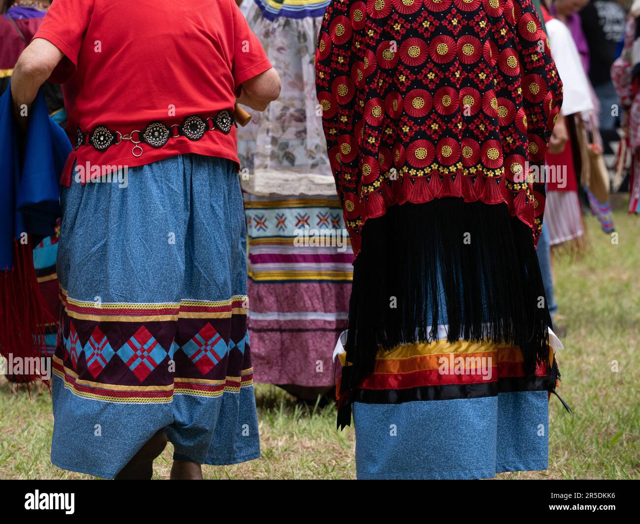 Female Native American or Indigenous women wearing skirts decorated ...