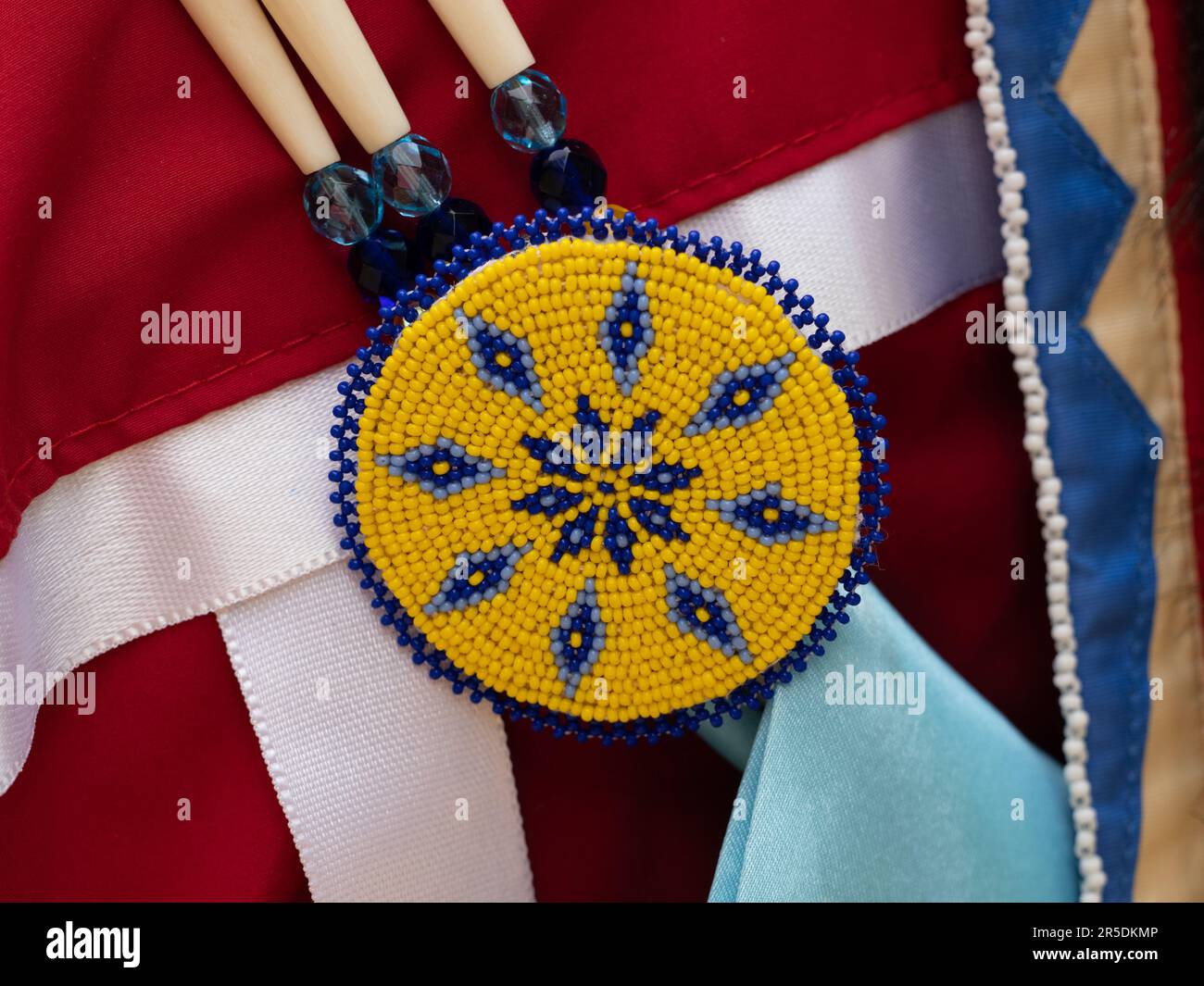 Blue and gold hand-beaded medallion worn by a Native American pow-wow ...