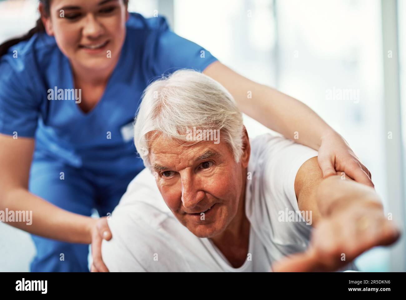 Her support is important. a senior man working on his recovery with a ...