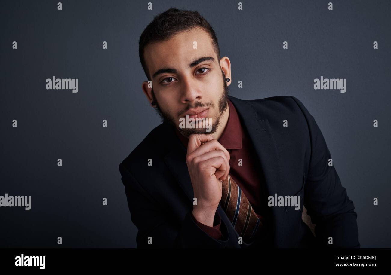The thinker. Studio portrait of a stylish young businessman looking ...