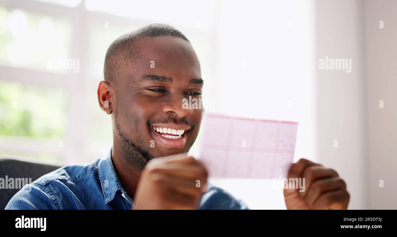 African Man Kissing Gamble Ticket. Lotto Game Card Stock Photo - Alamy