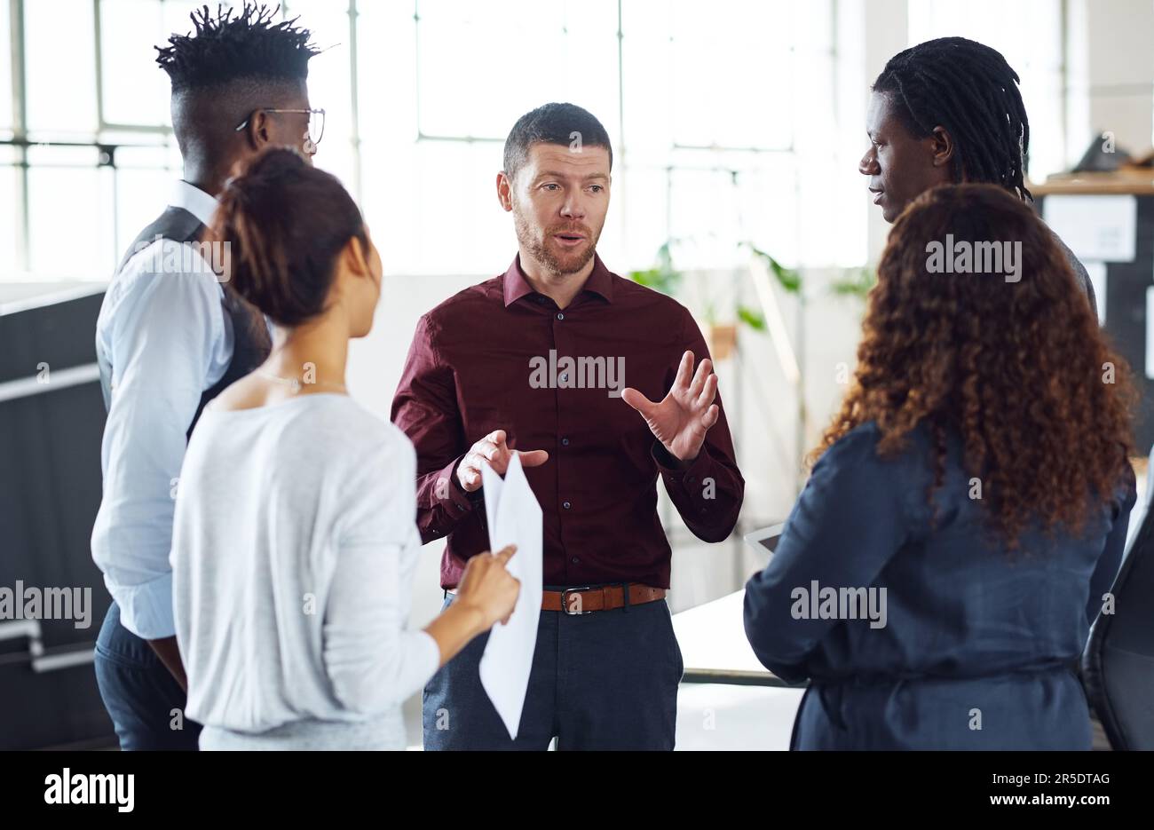Discussing their next big plan of action. a group of businesspeople ...