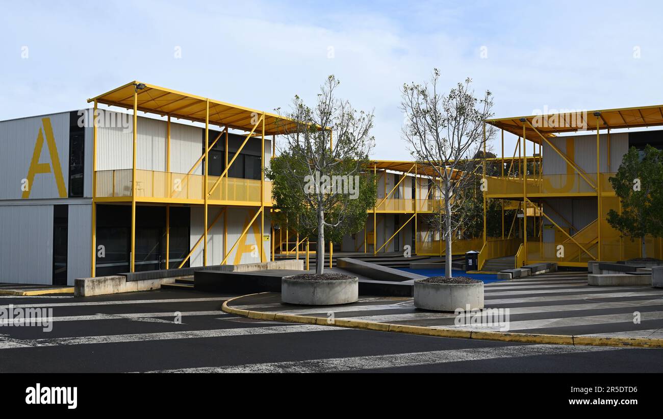 A collection of modern white and yellow buildings made of corrugated ...