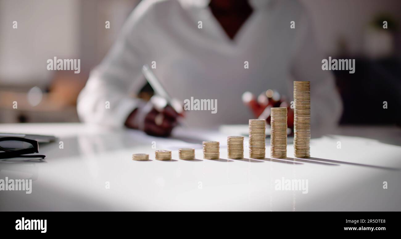African Accountant Using Calculator. Tax Money And Coins Stock Photo ...