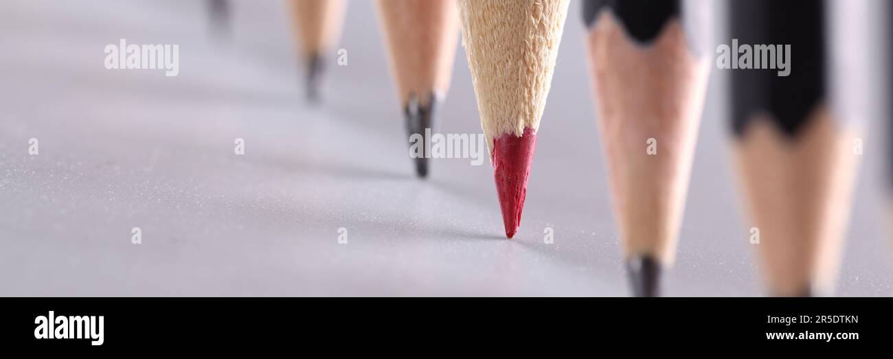 Red pencil stands out from crowd of many identical black pencils Stock ...
