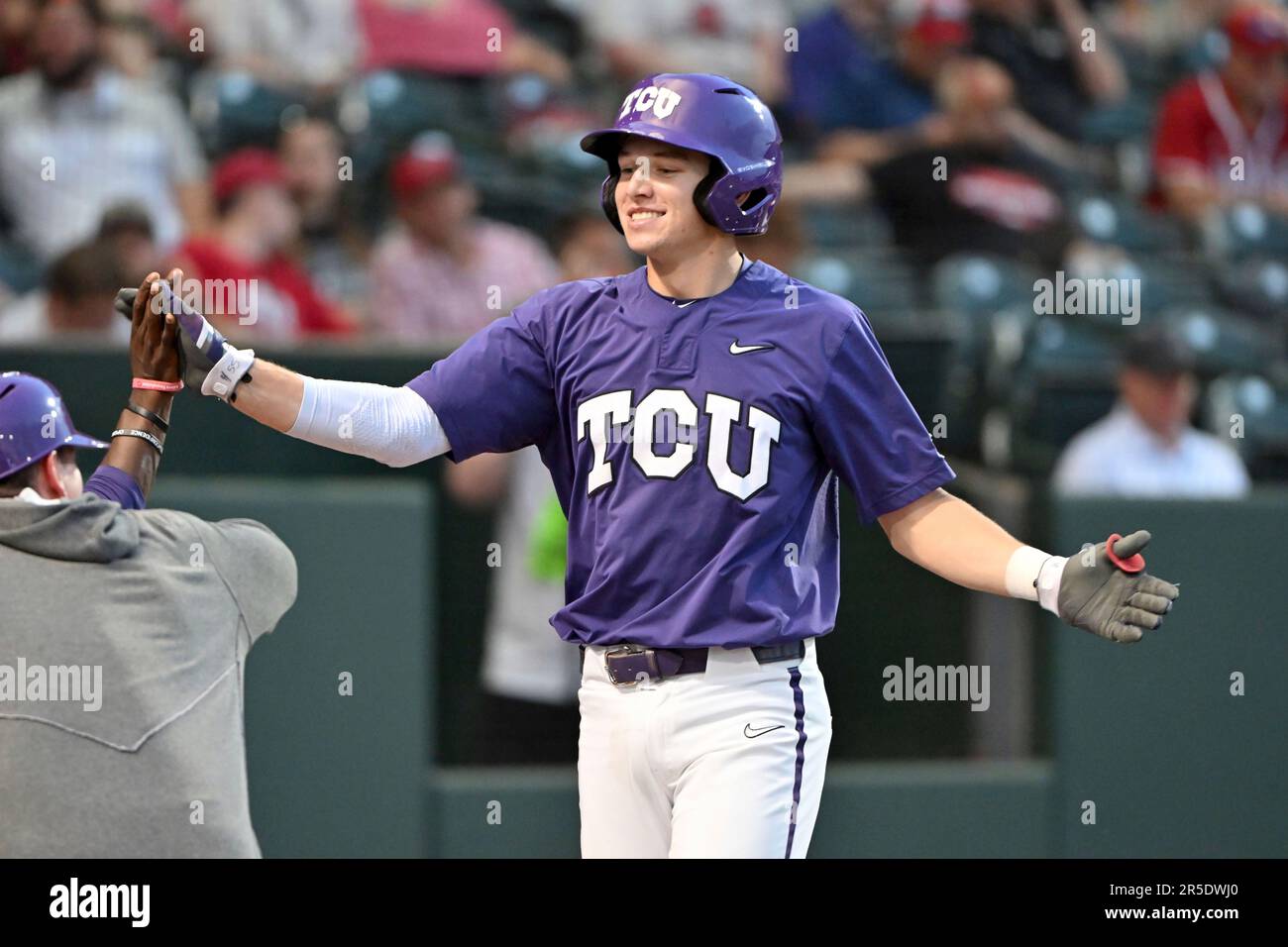 TCU batter Brayden Taylor is greeted by teammates after hitting home ...